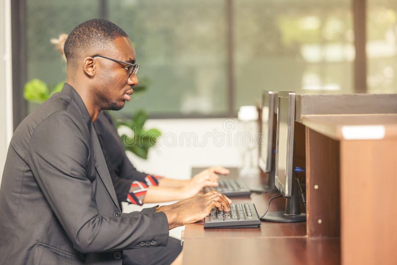 A Black Man Works on a Tablet Computer in the Hotel Lobby Stock Photo ...