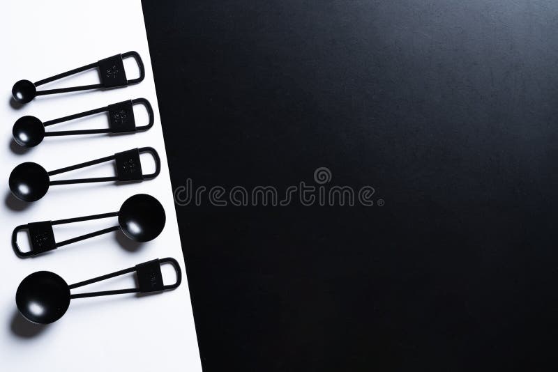 Black Measuring Spoons on Black and White Background Stock Photo ...