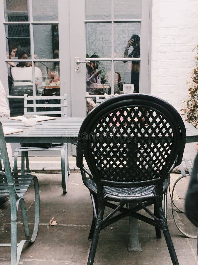 Black Metal Chair Beside Table At Daytime Stock Image - Image of home ...