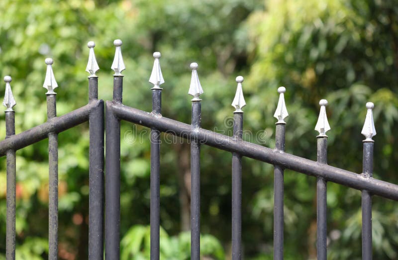 A Black Metal Gate with Spikes on it Stock Image - Image of park ...