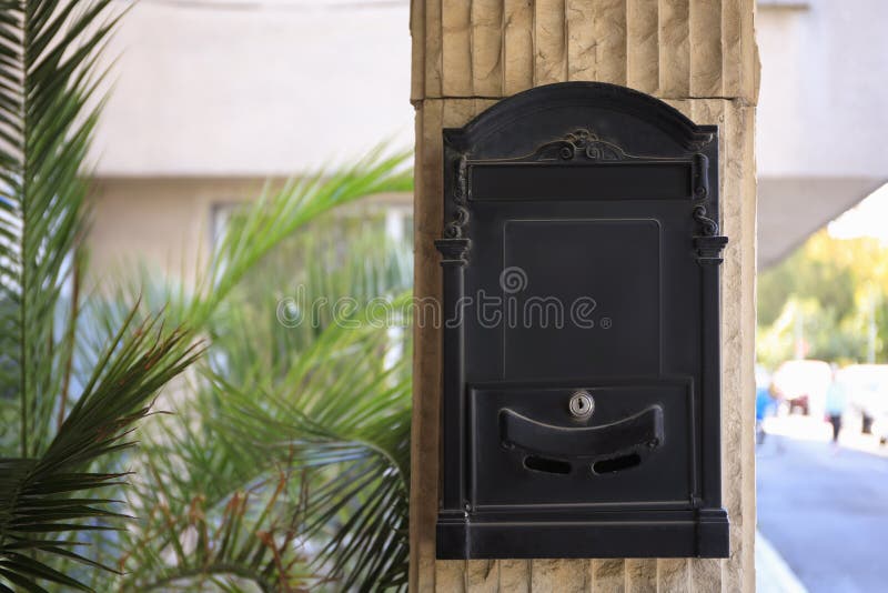 Black Metal Letter Box on Beige Column Outdoors, Space for Text Stock ...