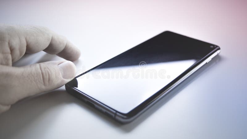 Black Mobile Phone Turned Off on a White Table with a Man S Hands Next ...