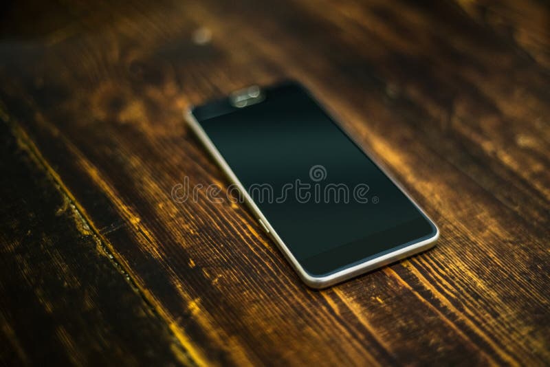 Black Mobile Phone on the Wooden Table Stock Photo - Image of network ...