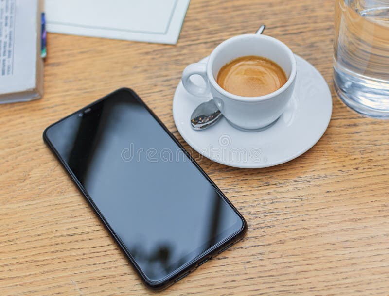 Black Mobile Smartphone with Blank Screen Notebook and Cup of Coffee ...