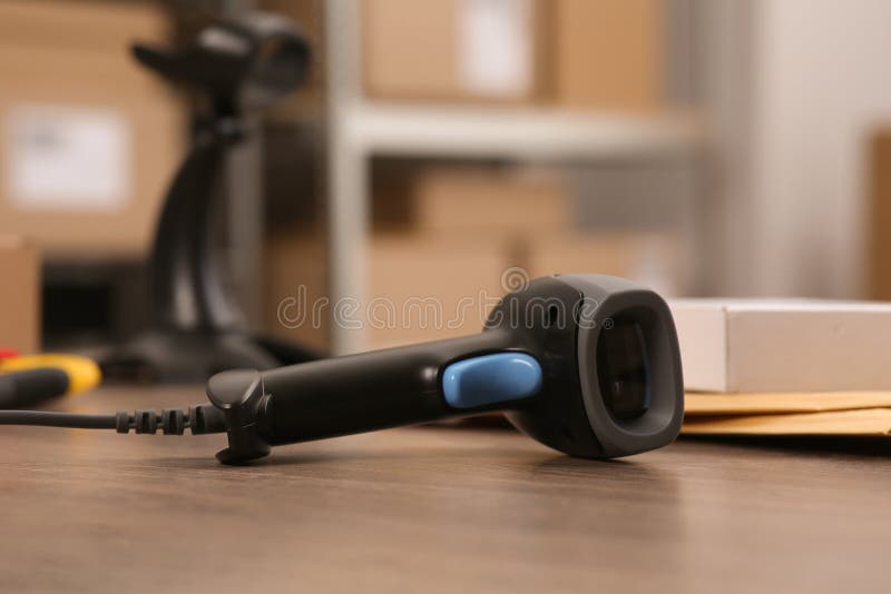 Black Modern Barcode Scanner on Wooden Table in Office, Closeup. Online ...