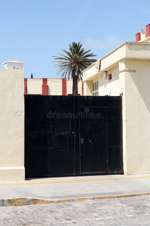 Black Wrought Gate To Property with Garden in the Background Stock ...