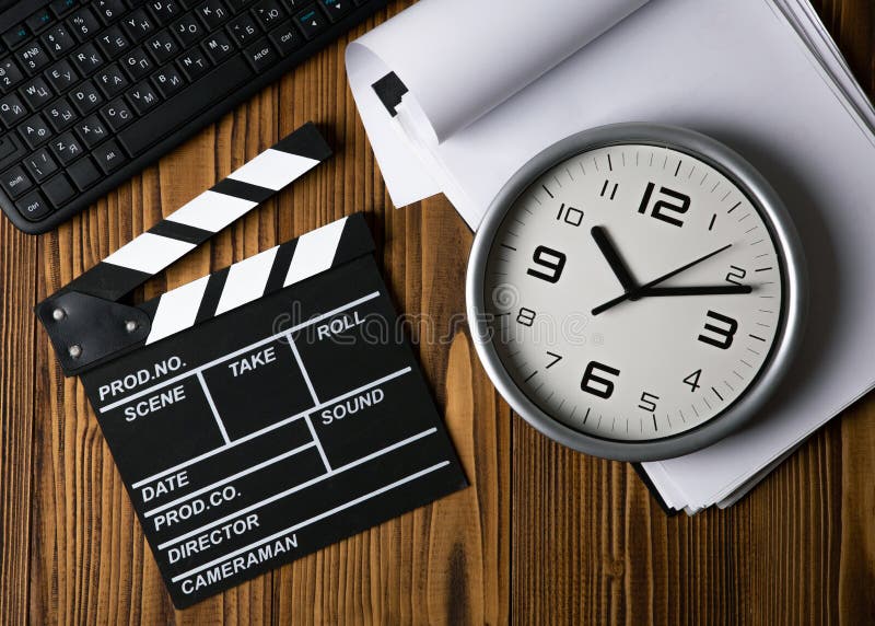 Black Movie Clapper with Keyboard and Script Sheets with Clock on a ...
