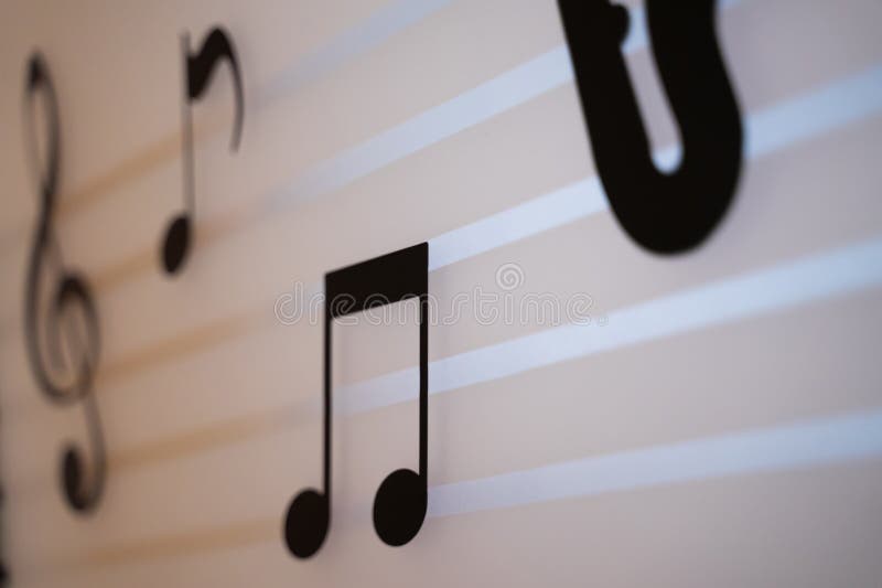Black Music Notes on a Cream Wall with Shadows in the Shade without ...