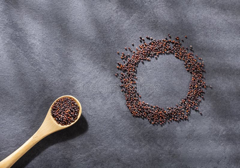 Black Mustard Grains, Small Round Seeds on the Wooden Spoon Stock Photo ...