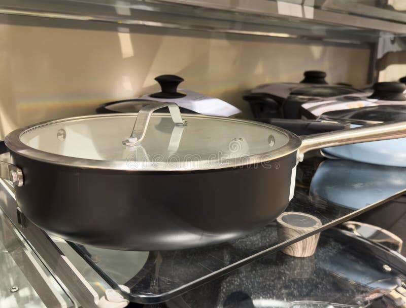 Black Non-stick Frying Pan with Glass Lid on Display Shelf Editorial ...