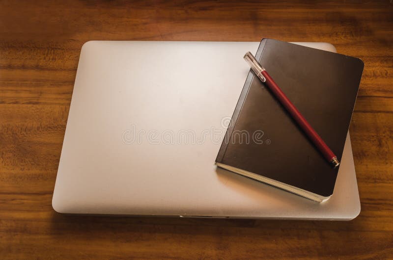 Black Notebook with a Pen To Write Work Notes on a Laptop Computer ...