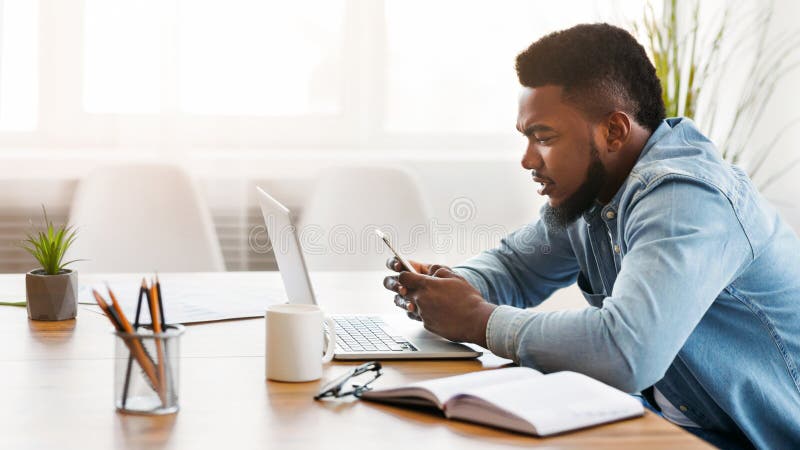 Black Office Worker Using Smartphone at Workplace Stock Photo - Image ...