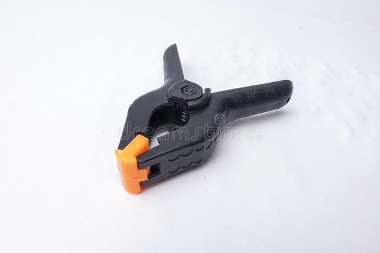 Black and Orange Plastic Spring Clamp Lying on White Background Stock ...