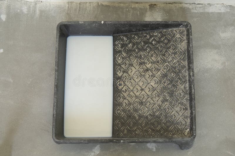 Black Paint Tray with White Primer during Interior Construction Project ...