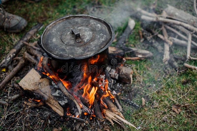 Black Pan with a Cover Standing on the Bonfire in the Forest Stock ...