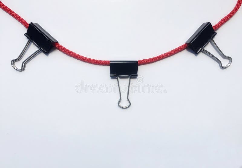 Black Paper Binder Clip Hanging on Red Rope Isolate on White Background ...