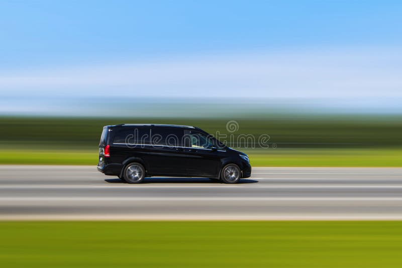 Black Passenger Minibus, Minivan is Driving on the Street with Blurred ...
