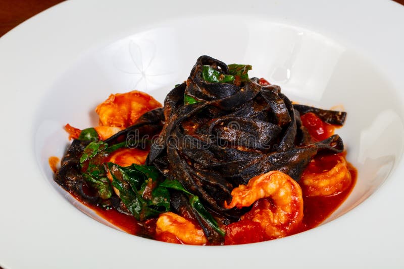 Black pasta with seafood stock image. Image of food - 129636199