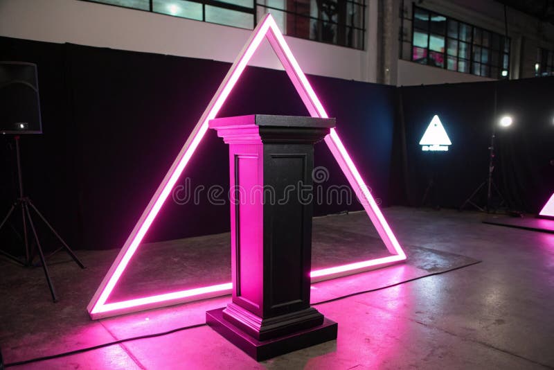 Black Pedestal with Neon Pink Light in Triangular Frame Stock ...