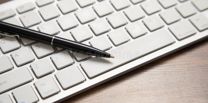Black Pen on the Computer Keyboard Stock Photo - Image of computer ...