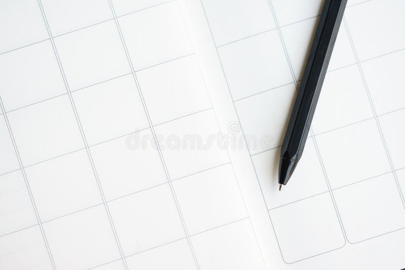 Black Pen Placed on a Notepad with Block Grid Pattern. Stock Image ...