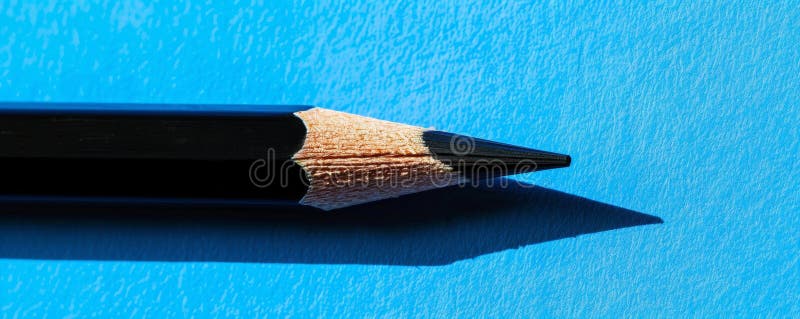 Black Pencil on Blue Background with Sharp Shadow Stock Photo - Image ...