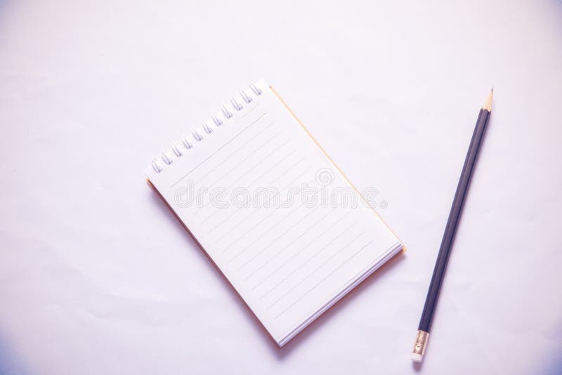 Black Pencil and Notebook Paper on White Background. Stock Image ...