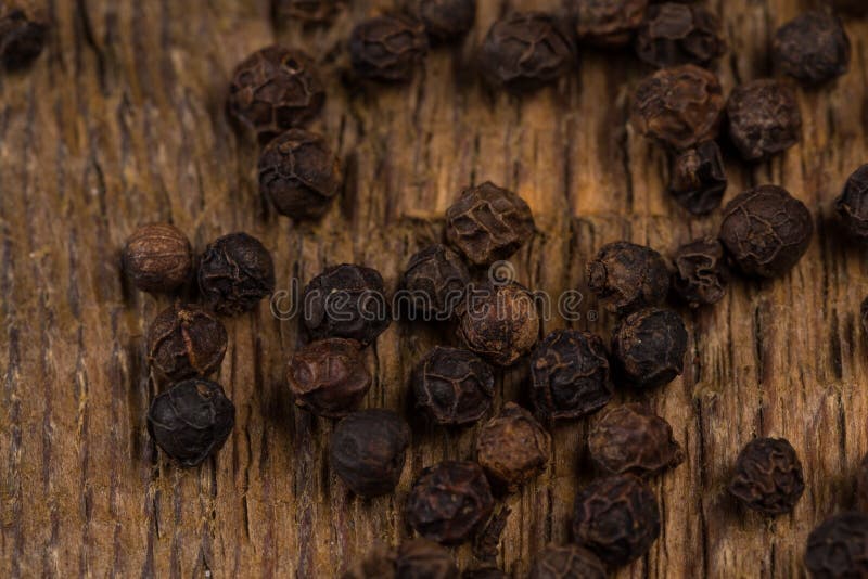 Black Pepper on Wooden Table Stock Image - Image of plate, color: 227937313