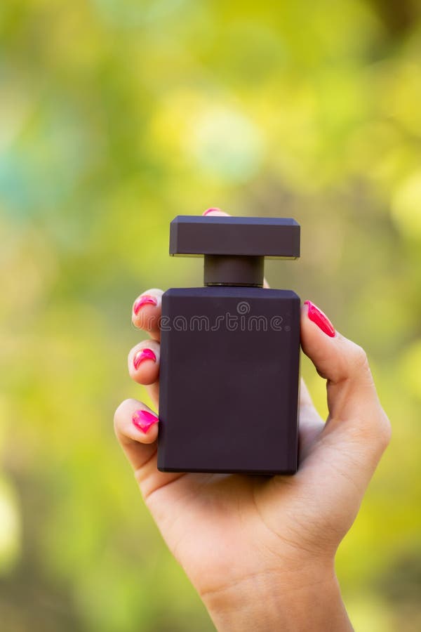 Black Perfume Bottle in Hand. Presenting Perfume Bottle. Presenting ...