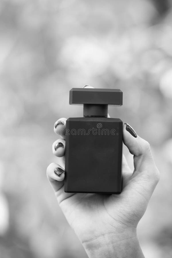 Black Perfume Bottle in Hand. Presenting Perfume Bottle. Presenting ...