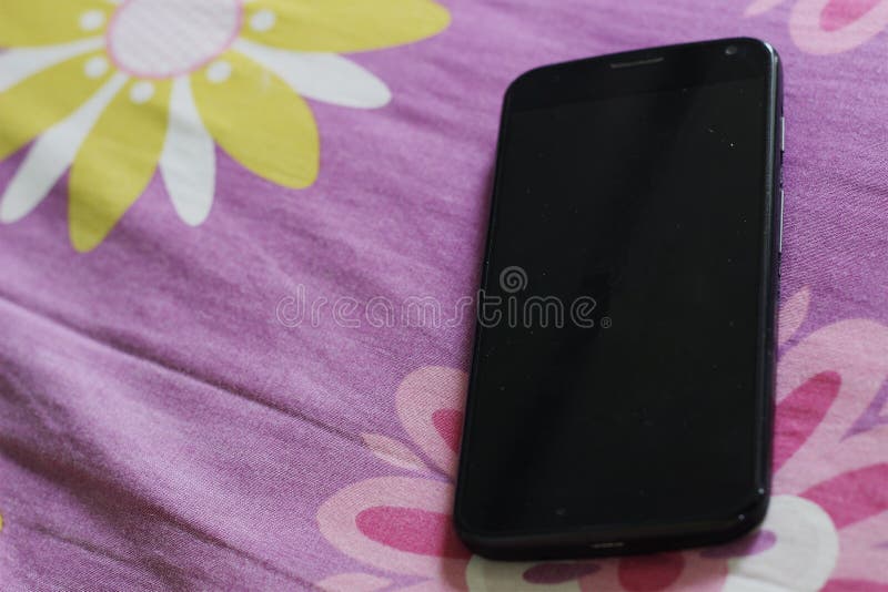 Black Phone Laying on the Bed Stock Image - Image of room, black: 96598221