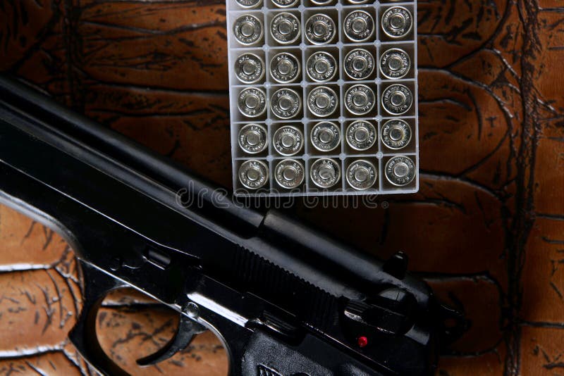 A Black Pistol with Bullets on a Wooden Table Stock Image - Image of ...