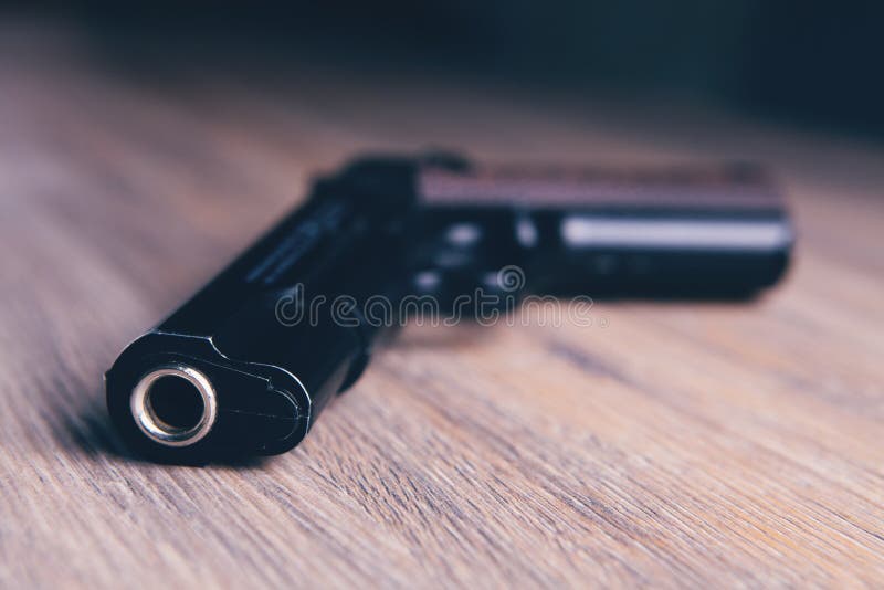 Black Pistol Lying on the Table Stock Photo - Image of risk, blur ...