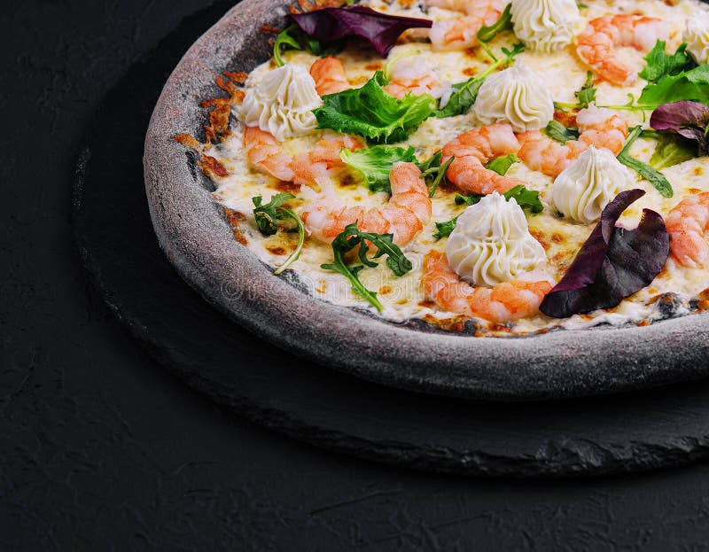 Black Pizza with Seafood on a Wooden Round Plate on a White Stock Image ...