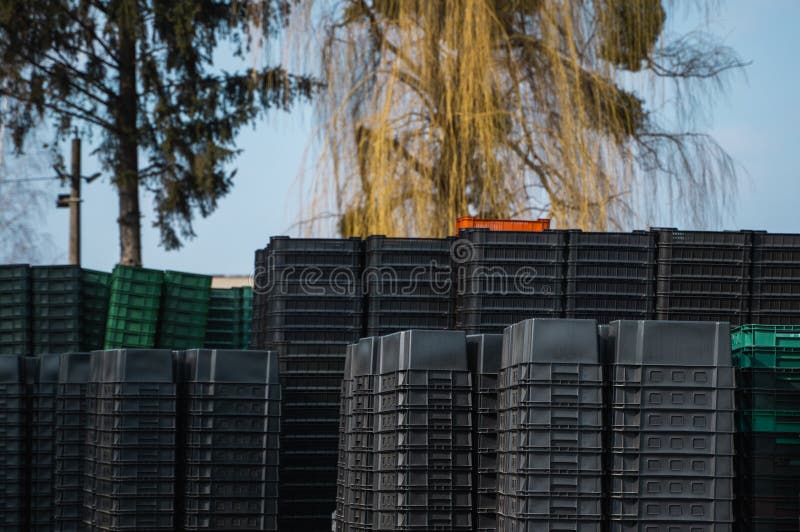 Black Plastic Boxes in a Warehouse Outdoor. Stock Image - Image of pile ...