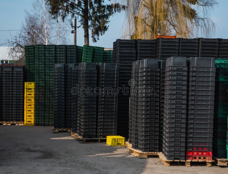Black Plastic Boxes in a Warehouse Outdoor. Stock Photo - Image of pile ...