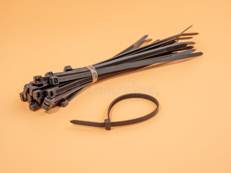Black Plastic Cable Ties on an Orange Background. Stock Photo - Image ...