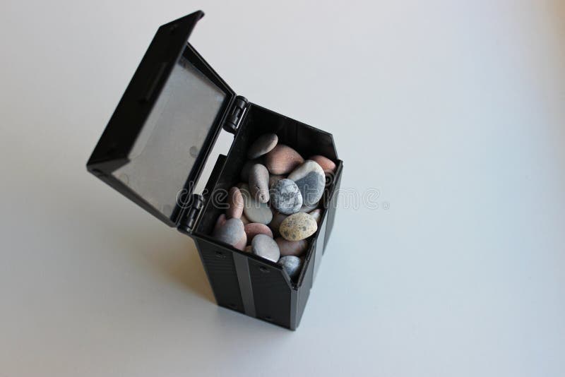 Black Plastic Container Mockup Full of Smooth Pebbles on a Clean White ...