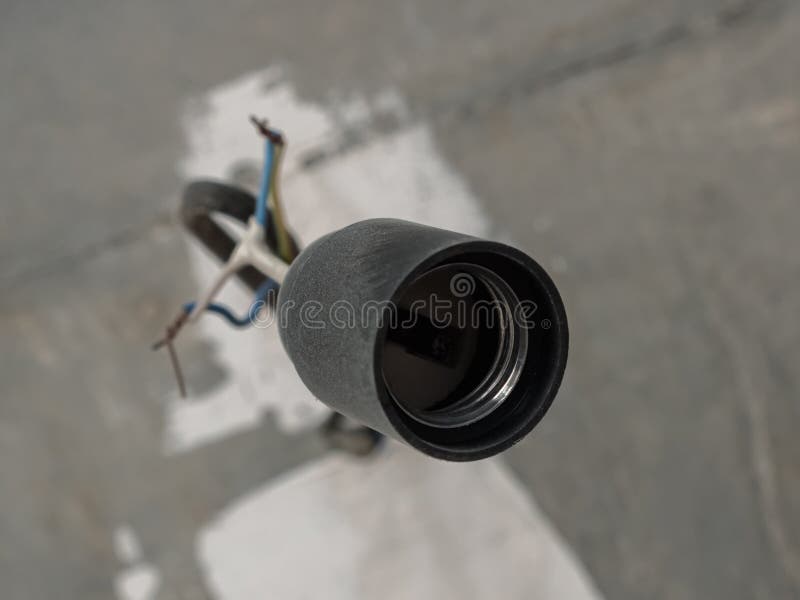 A Black Plastic Empty Lamp Socket Hangs from the Ceiling. Close-up. the ...