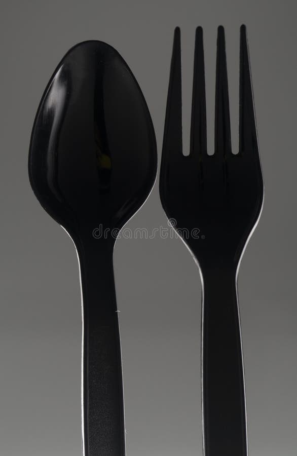 Black Plastic Fork and Spoon with Water Drops Showing Reflections and ...