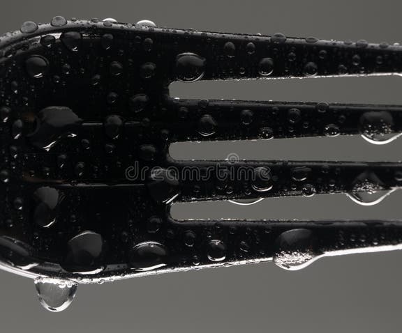 Black Plastic Fork and Spoon with Water Drops Showing Reflections and ...