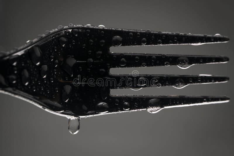 Black Plastic Fork and Spoon with Water Drops Showing Reflections and ...