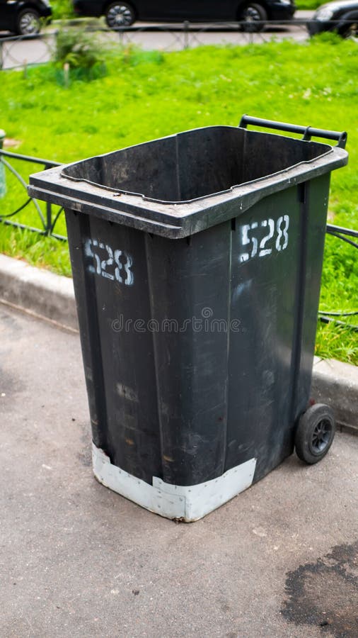 Black Plastic Garbage Collection Container on the Street with the Lid ...