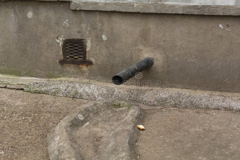 Black Plastic Rainwater Drain Pipe at the Base of the House Stock Photo ...