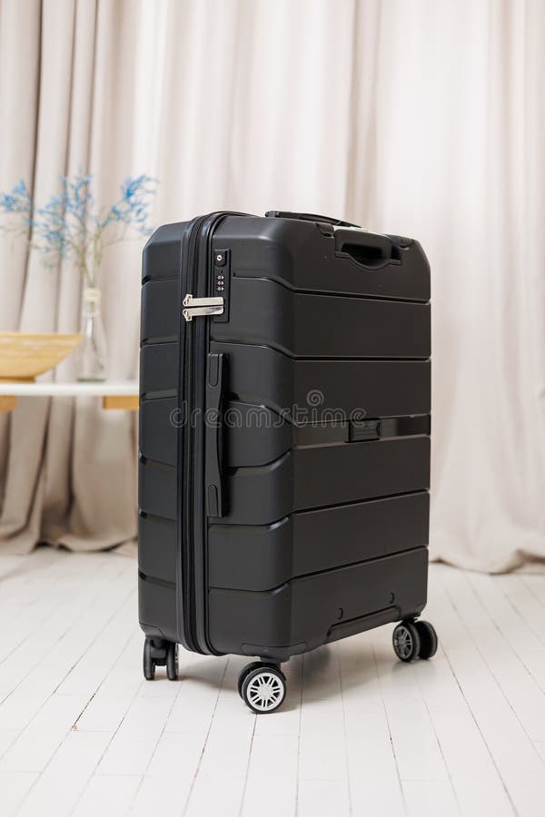 Black Plastic Strong Suitcase for Carrying Luggage on a White Stock ...