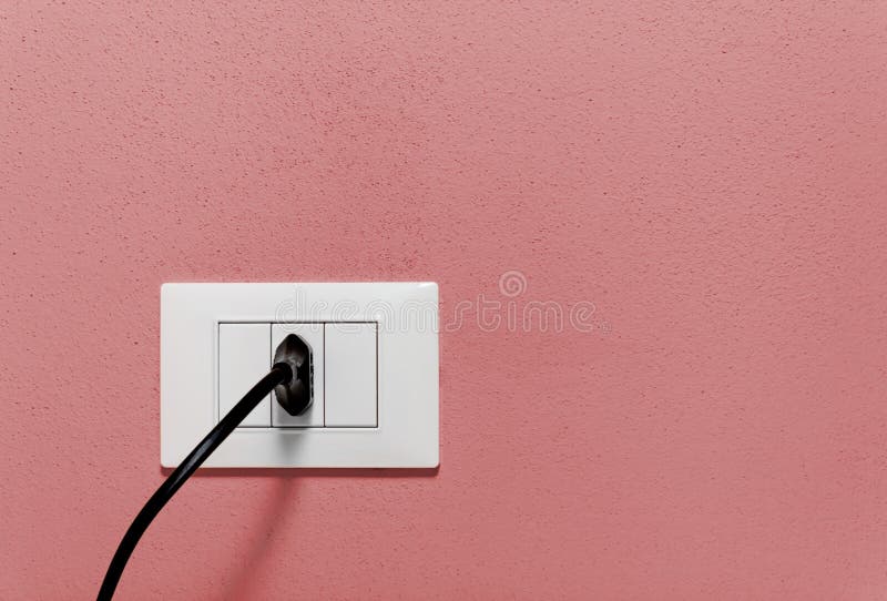 Black Plug in a Wall Socket on a Red Wall Stock Image - Image of ...