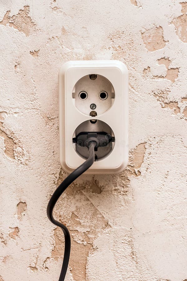 Black Plug in a White Double Outlet on a White Plaster Background in a ...