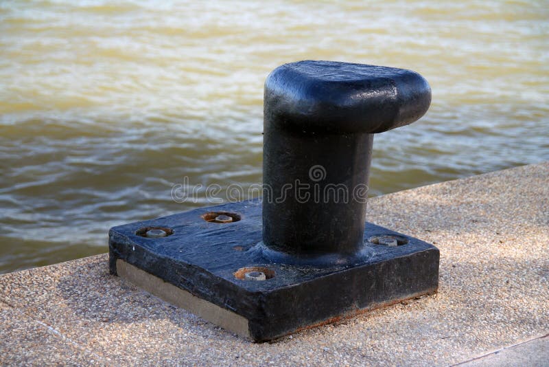 A Black Port Iron Bollard on the Water Stock Image - Image of dramatic ...