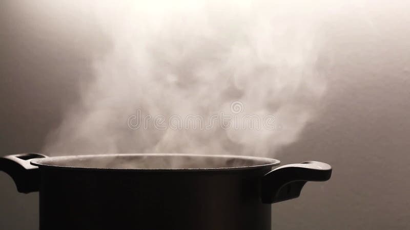 Black Pot with Steam Rising from Boiling Water in a Bright Kitchen ...