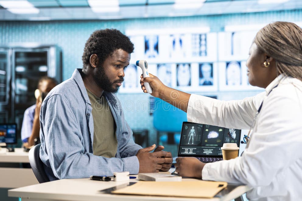 Black Practitioner Takes the Temperature during Routine Checkup at the ...